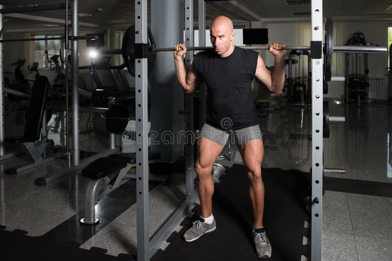 Fitness Man Using Barbell Exercising Legs Inside Gym Stock Image ...