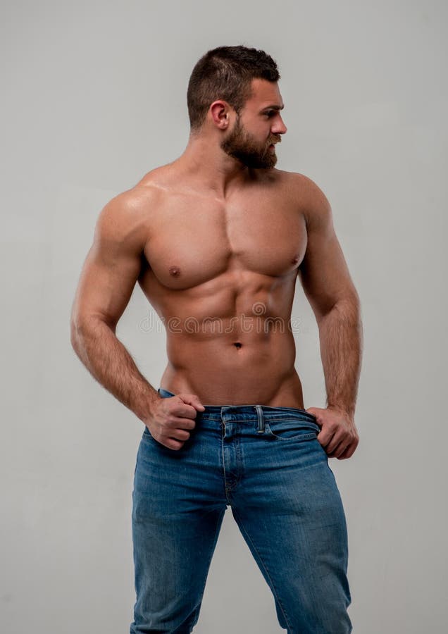 Muscled man in blue jeans stock image. Image of lean - 136369619