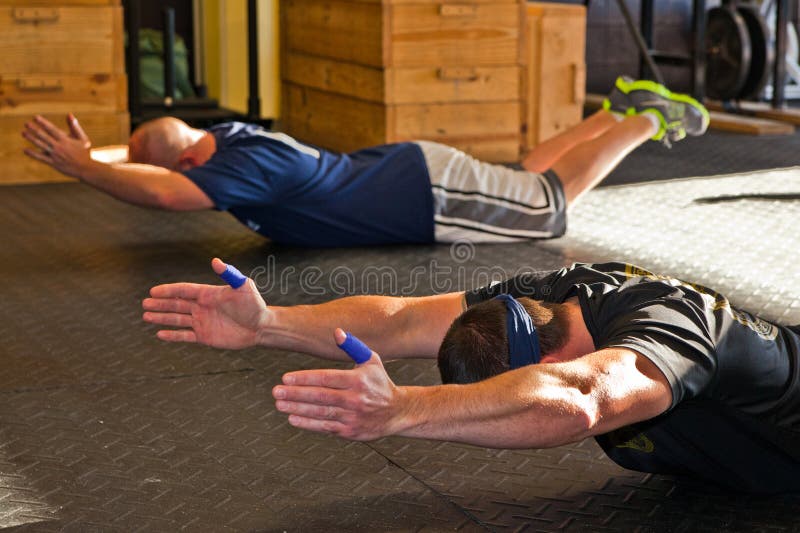 Fitness Partners Performing Superman Exercise in Gym Setting Editorial ...