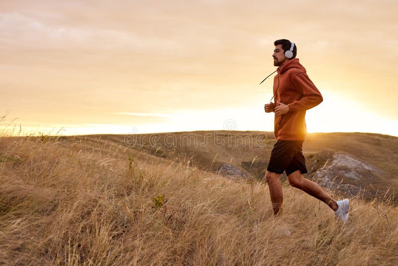 Sport and Fitness Runner Man Running on Field Training for Marathon ...