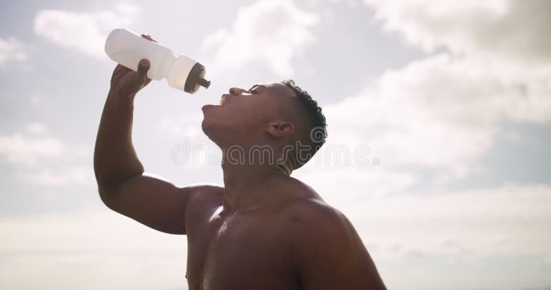 Black Man, Drinking Water and Fitness in Gym for Exercise Break and ...