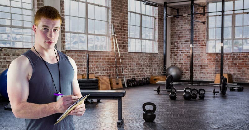 Fitness Trainer Writing on Clipboard in Gym Stock Photo - Image of ...