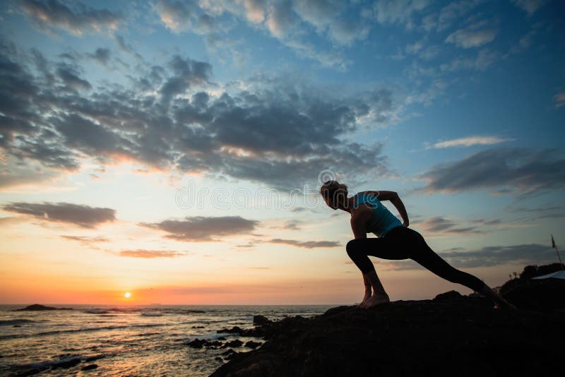 Fitness Woman Doing Yoga Exercises on the Ocean Coast Stock Photo ...