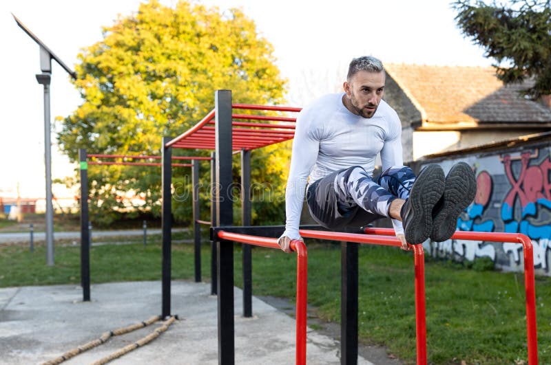 Fitness Workout for Frontal Abs on Parallel Bars, Young Man Working Out ...