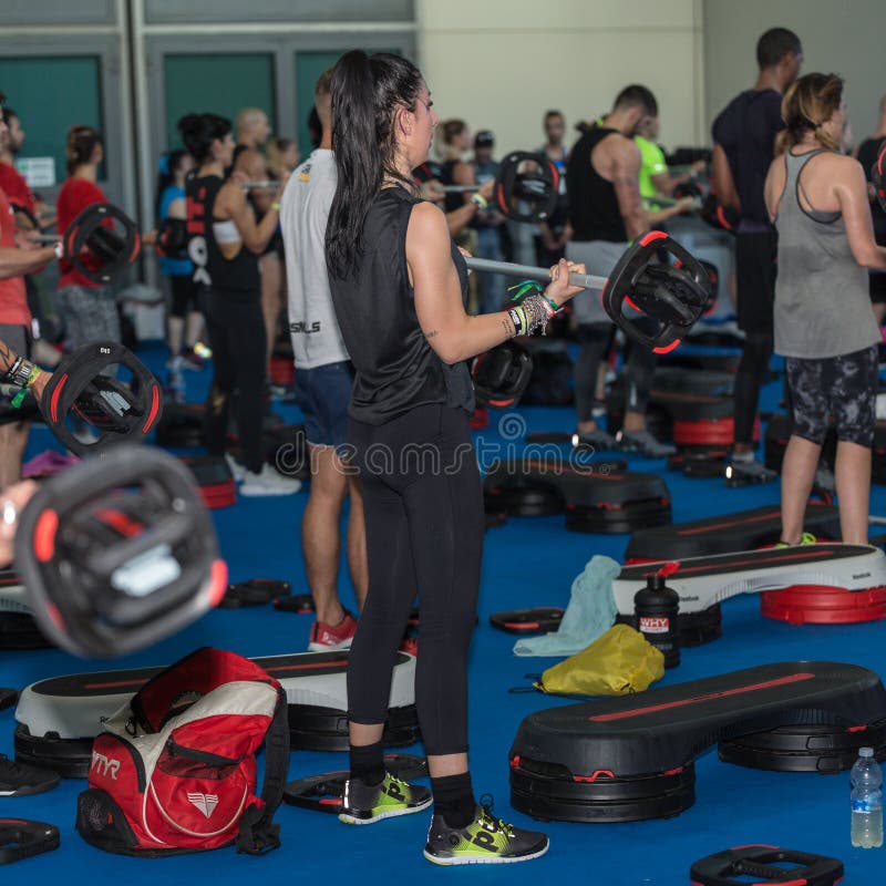 Fitness Workout in Gym: People Doing Exercises in Class with Step ...