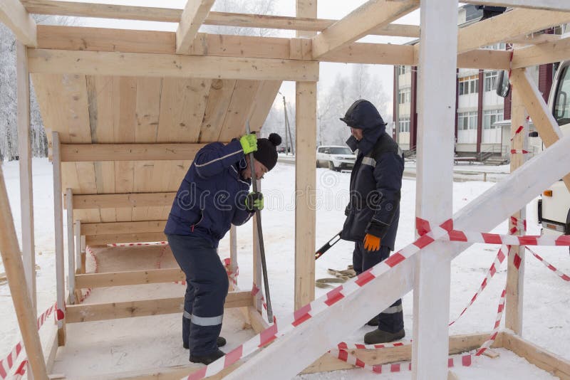 Fitter with a Metal Crowbar in Hand at the Construction of a Wooden ...