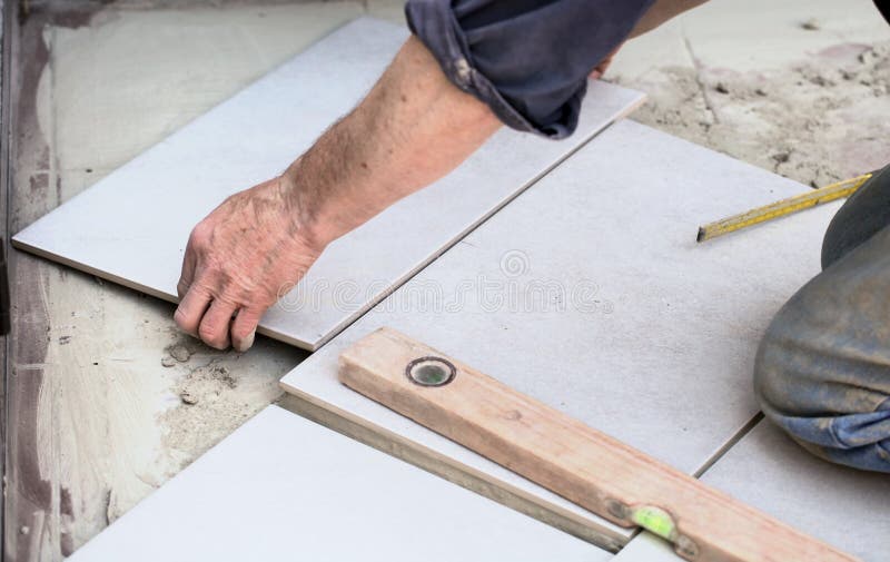 Man installing floor tile stock image. Image of skilled - 16263681