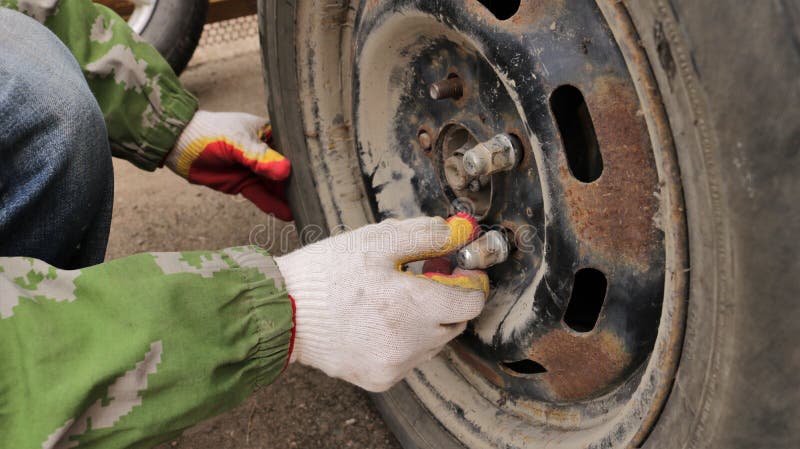 Fitting a Nut on a Stud when Changing a Wheel Stock Image - Image of ...
