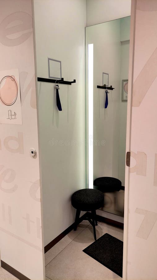 Fitting Room Empty with Mirror and Clothes Hanger Stock Photo - Image ...