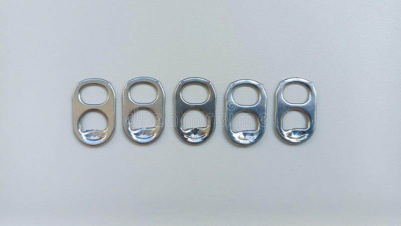 Five Aluminum Can Pull Tabs in a Row Stock Image - Image of ...