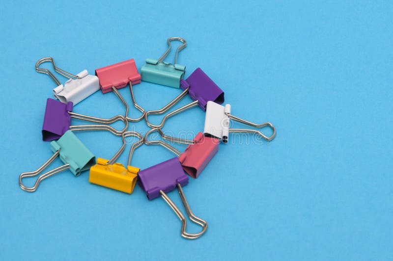 Five Binder Clips of Different Colors on a Gray Background As ...