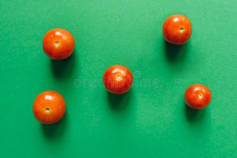 Five Cherry Tomatoes on a Green Background. Stock Photo - Image of ...