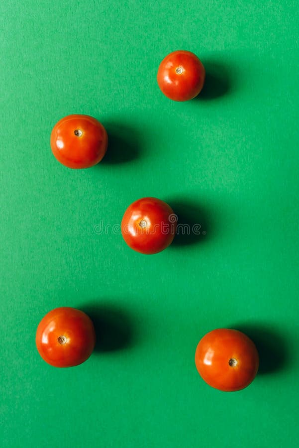 Five Cherry Tomatoes on a Green Background. Stock Image - Image of ...
