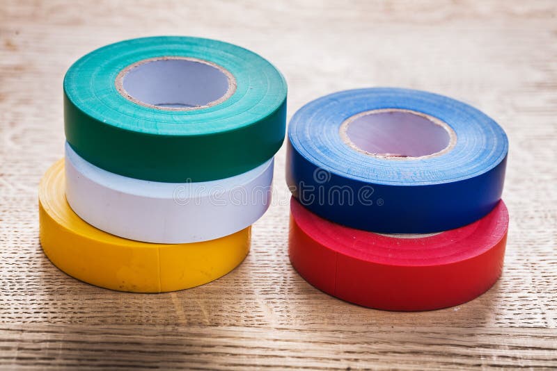 Five Colored Rolls of Insulating Tape on Wooden Stock Photo - Image of ...