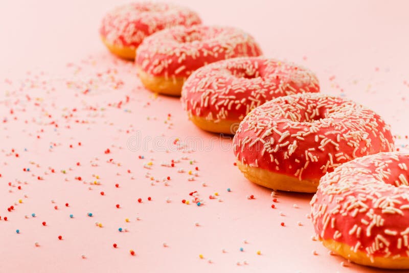 Five Coral Donuts Standing in a Line. Donuts with Icing Stock Photo ...