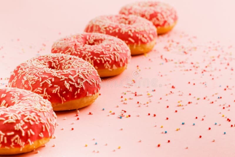 Five Coral Donuts Standing in a Line. Donuts with Icing Stock Photo ...