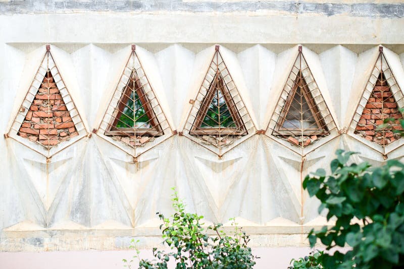 Five Diamond-shaped Windows, Some of Which are Bricked, on a White Wall ...