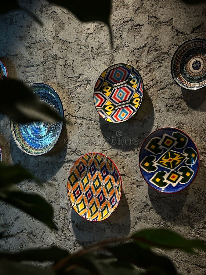 Five Different Colored Plates Hang on the Wall Stock Photo - Image of ...