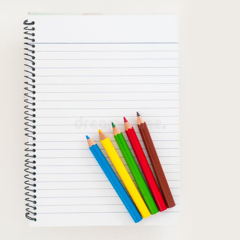 Five Different Colors Pencil on Empty Clear Page of Notebook Stock ...