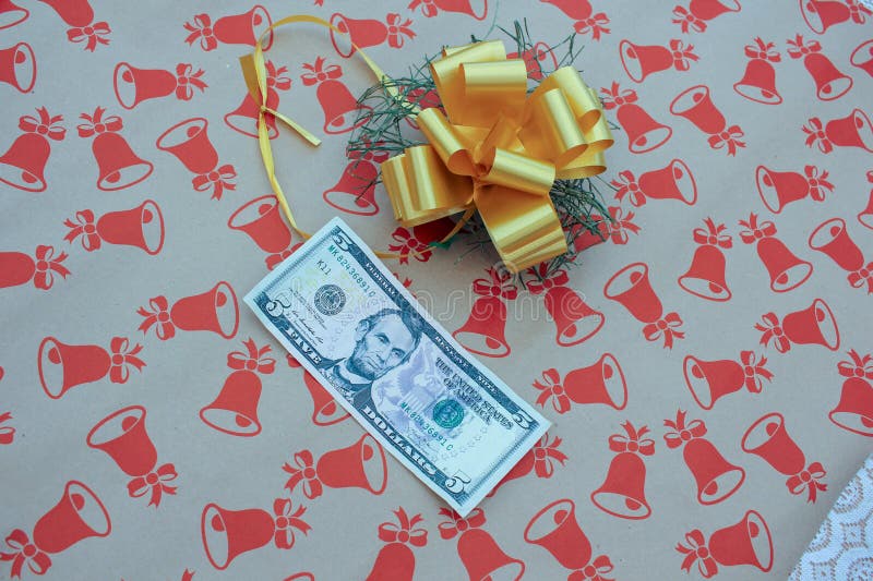 A Five Dollar Bill and a Christmas Present Stock Image - Image of ...