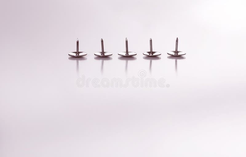 Five Drawing Pins, Reflected in a White Surface Stock Image - Image of ...