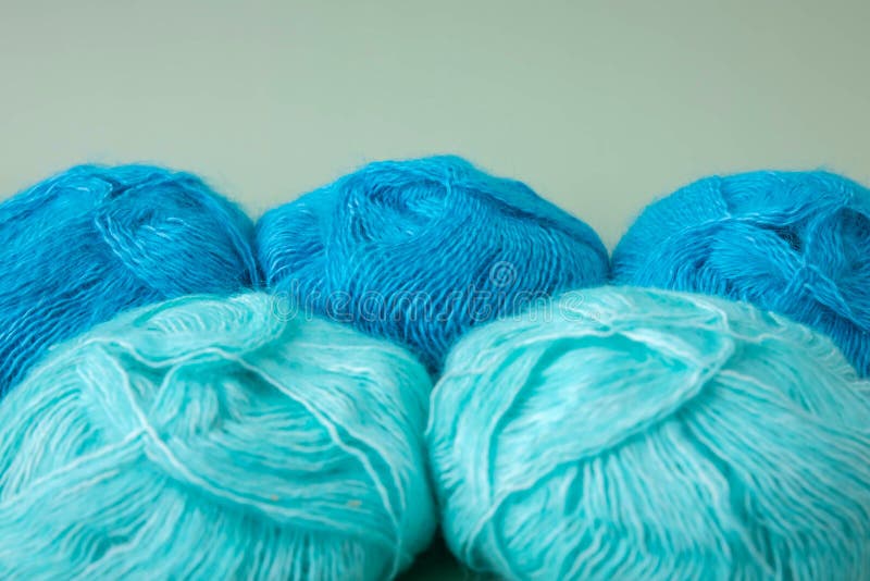 Five Fluffy Skeins of Blue and Turquoise Yarn Selective Focus Knitting ...