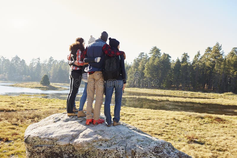 Five Friends Standing on a Rock in Countryside, Back View Stock Image ...