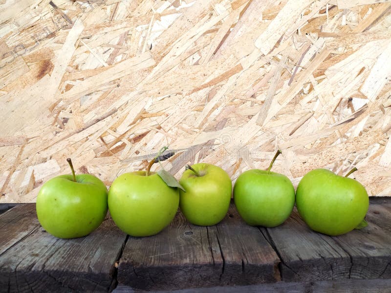 Five Green Apples in a Row on a Textured Wooden Table Stock Image ...