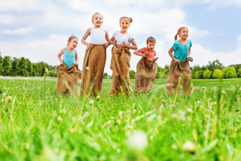 Five Kids Having Fun Jumping in Sacks Stock Photo - Image of play, kids ...