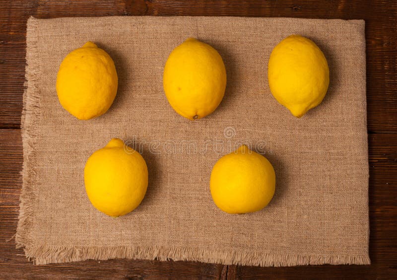 Five Lemons with Lemon Tree Leaves on Yellow Stock Photo - Image of ...