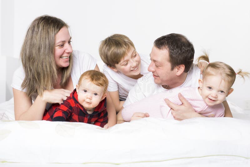 Five Member Young Family Having Fun in Bed Stock Photo - Image of ...