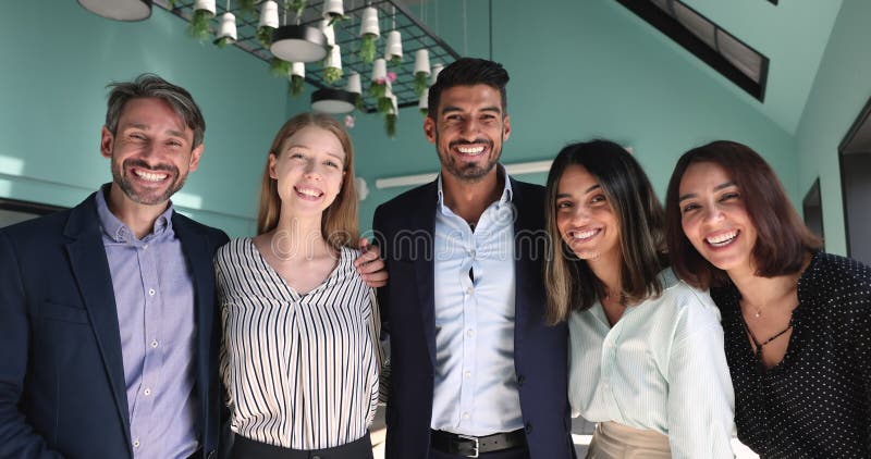 Five Motivated and Enthusiastic Multiethnic Workmates Smile Looking at ...