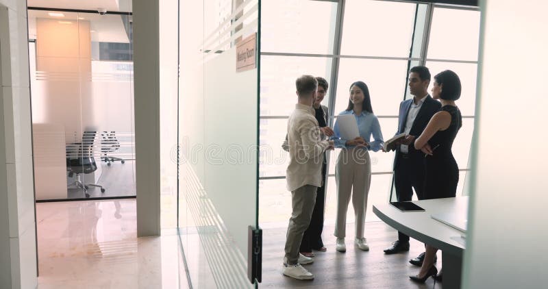 Five Multiethnic Businesspeople Talking Standing in Conference Room ... Five Multiethnic Businesspeople Talking Standing in Conference Room ...