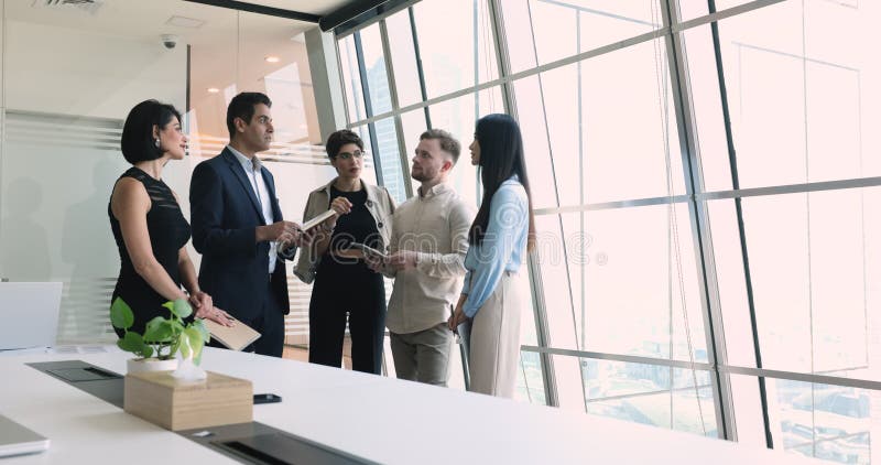Five Multiethnic Businesspeople Talking Standing in Conference Room ... Five Multiethnic Businesspeople Talking Standing in Conference Room ...