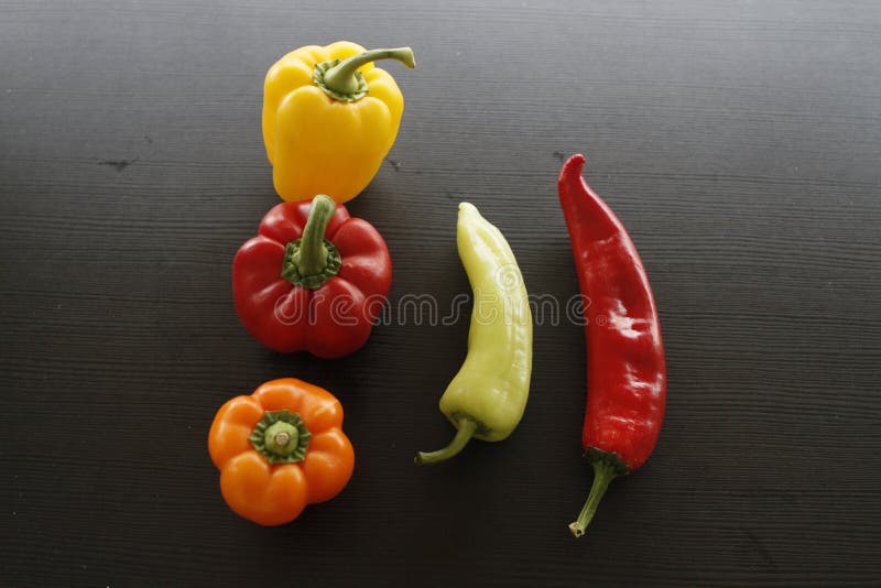 Five Peppers on Table Shot from Top Stock Image - Image of dinner ...