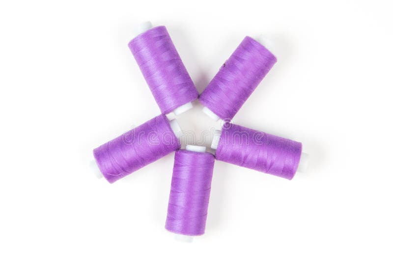 Five Purple Sewing Threads Laying in a Circle on a White Background ...
