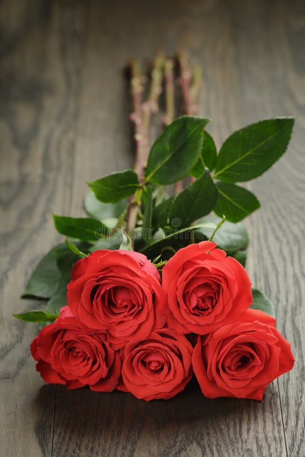 Five Red Roses on Old Oak Table Stock Photo - Image of closeup, flower ...