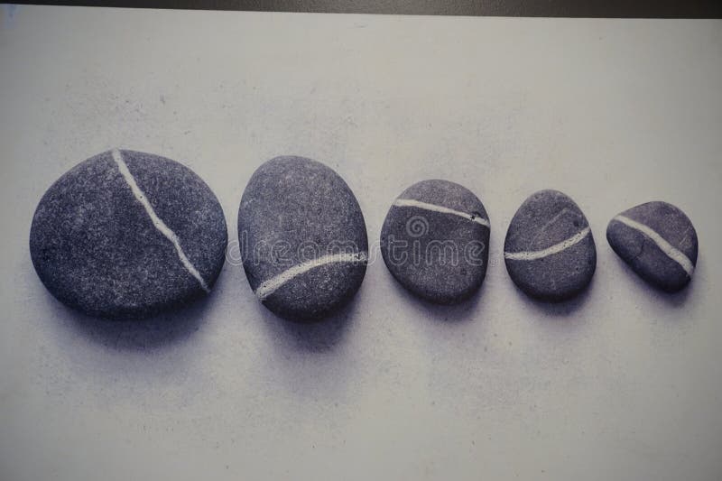 Five Rocks in a Line on White Surface, Minimalist and Serene ...