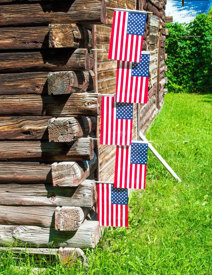 Small American Flags on the Corner of a Rustic Log Barn Stock Photo ...
