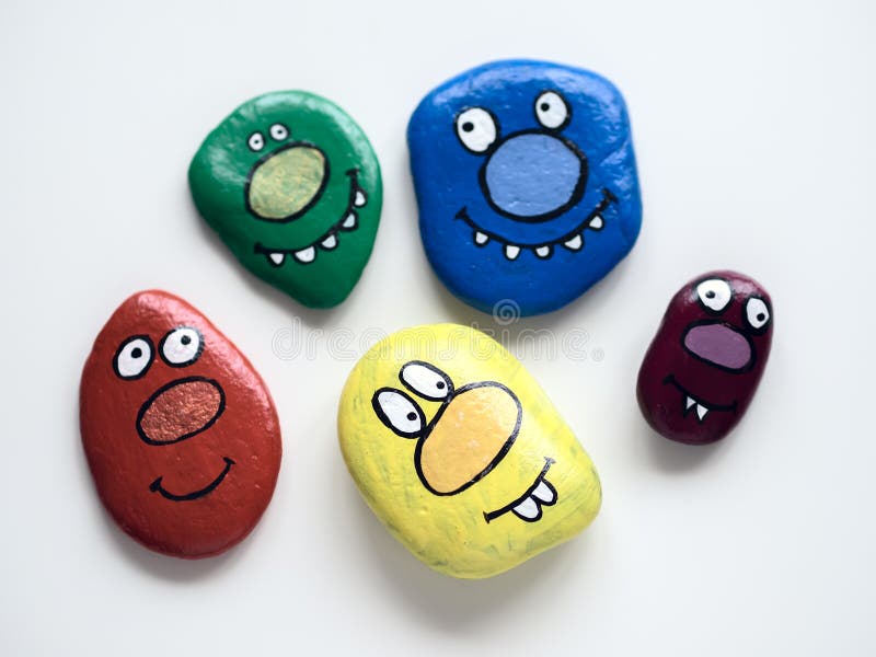 Five Smiling Faces of Monsters. Painted Acrylic Pebbles. Stock Image ...