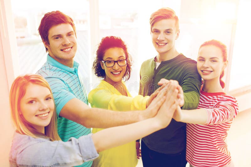 Five Smiling Students Giving High Five at School Stock Photo - Image of ...