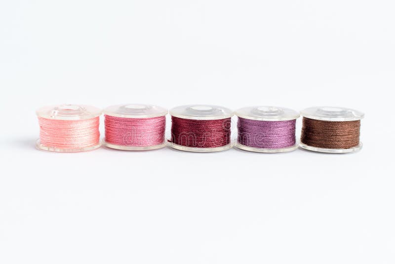 Five Spools of Burgundy, Light Pink, Pink, Mauve and Brown Threads ...
