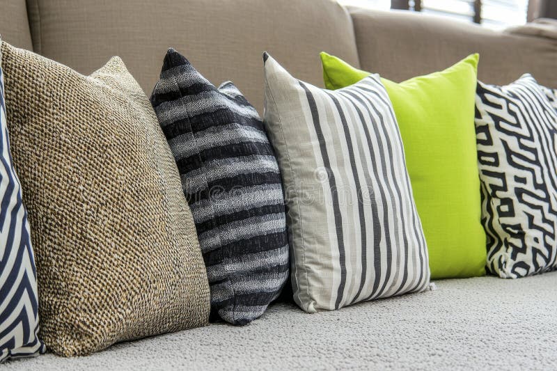 Five Textured Pillows on Beige Couch Geometric Patterns and Stripes ...