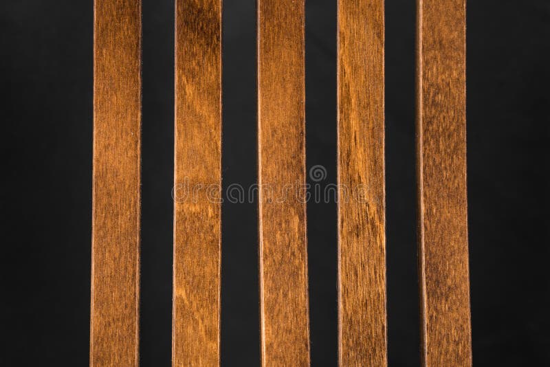 Five Vertical Wooden Bars Against the Black Fabric Background Stock ...
