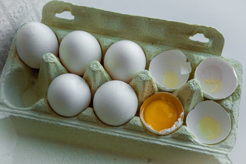 Five Whole White Eggs and One Broken Egg with Yellow Yolk and Egg ...