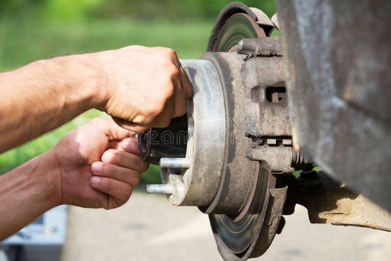 Fixing a car wheel stock image. Image of male, mechanic - 95627611