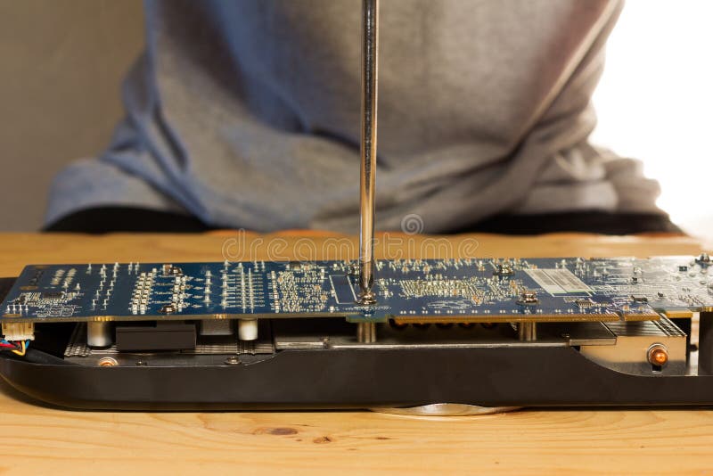 Fixing Computer. Screwdriver Unscrews the on the Video Card Stock Photo ...