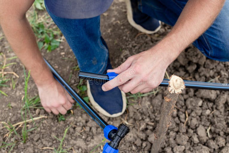 Fixing and Connecting Pipes Using a Fitting. Man Installs an Automatic ...