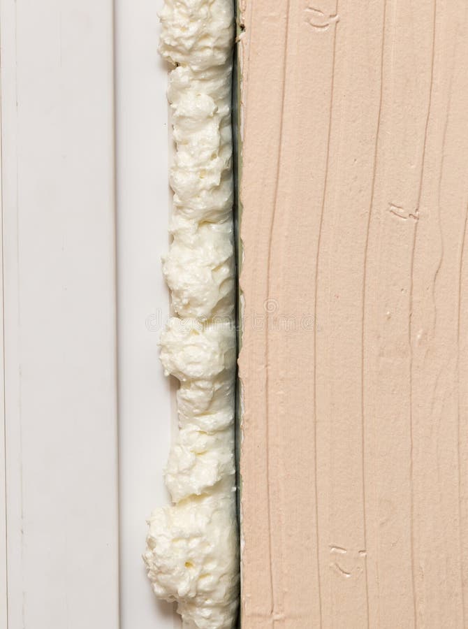 Fixing the Gap in the Door with Construction Foam Stock Photo - Image ...