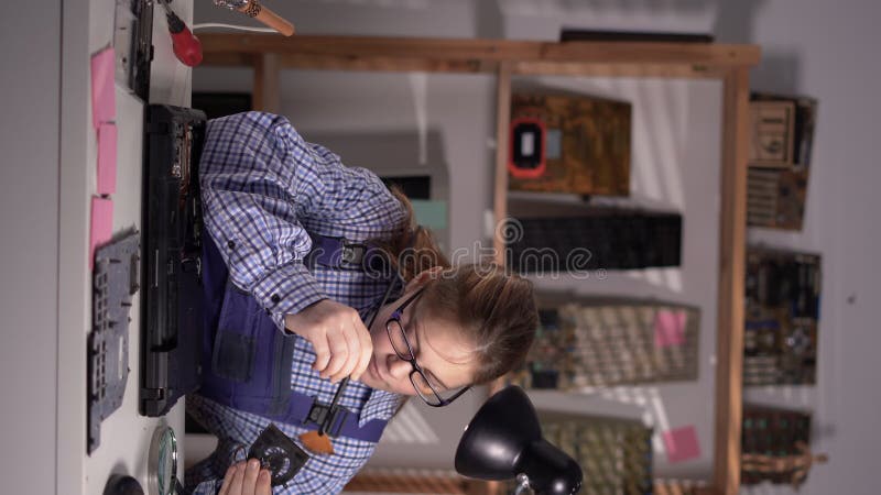 Fixing Laptop. Female Engineer Disassembling a Notebook and Cleaning ...